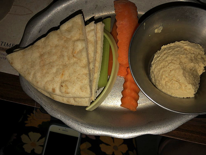 Simple yet satisfying – warm pita triangles, fresh vegetables, and creamy hummus provide a tasty alternative for those seeking lighter fare.