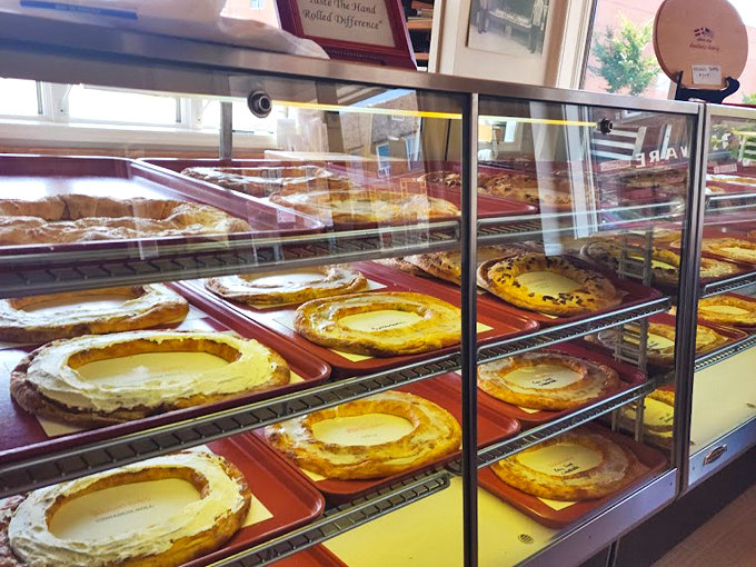 Golden, flaky cheesecakes line the display case, their perfect circles promising creamy indulgence with every slice.