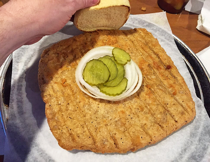 When your tenderloin arrives looking like it's trying to escape the plate, you know you've hit the jackpot of Midwestern cuisine.
