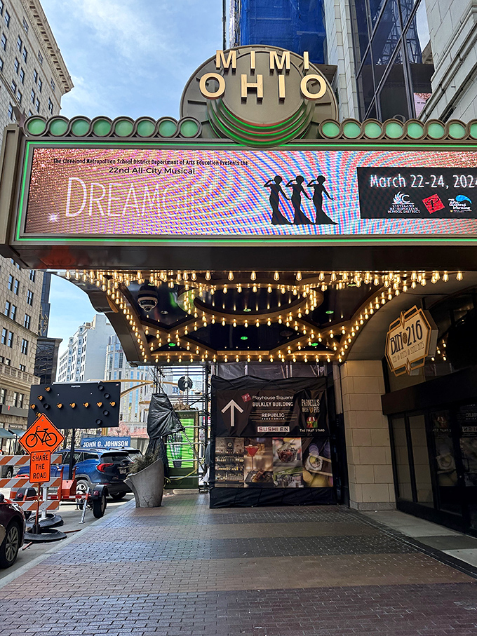 The iconic MIMI Ohio Theatre marquee glows with vintage charm, promising entertainment beneath the district's crystal canopy.