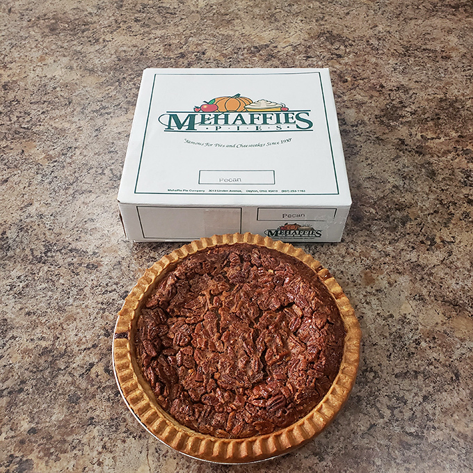 This pecan masterpiece isn't just dessert &ndash; it's architecture, chemistry, and art rolled into one perfect circle. The glossy filling practically winks at you.