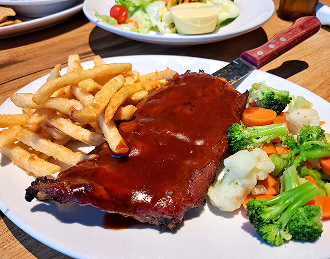 These fall-off-the-bone BBQ ribs arrive glistening with sauce &ndash; meat so tender it practically surrenders at the sight of your fork.