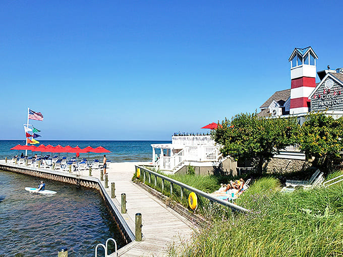 A red-and-white lighthouse stands sentinel over the marina, looking like it jumped straight out of a Wes Anderson film into Michigan's most picturesque corner.