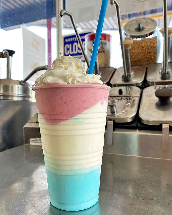 A technicolor dream in a cup &ndash; layers of blue, white, and pink create a frozen symphony that tastes even better than it looks.