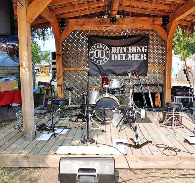 The wooden stage awaits local musicians, where "Ditching Delmer" will soon transform shopping background noise into toe-tapping entertainment for weary treasure hunters.
