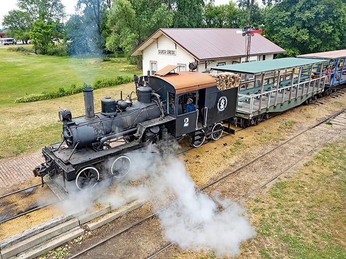 Steam billows dramatically from this working locomotive, proving that the most impressive special effects don't require computers, just water, fire, and brilliant 19th-century engineering.