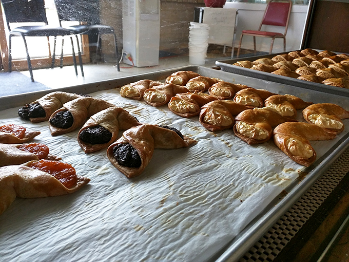 Golden-brown strudel pastries glisten on baking sheets, their flaky layers the result of dough stretched paper-thin by hand, not machines.