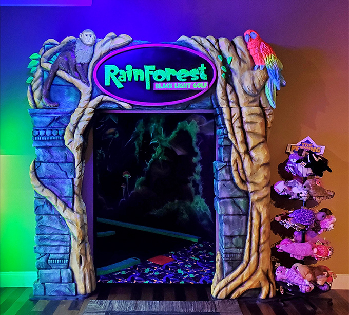 The entrance to the mini-golf area looks like a portal to another dimension, complete with monkey sentinels and a colorful parrot welcoming adventurous putters.
