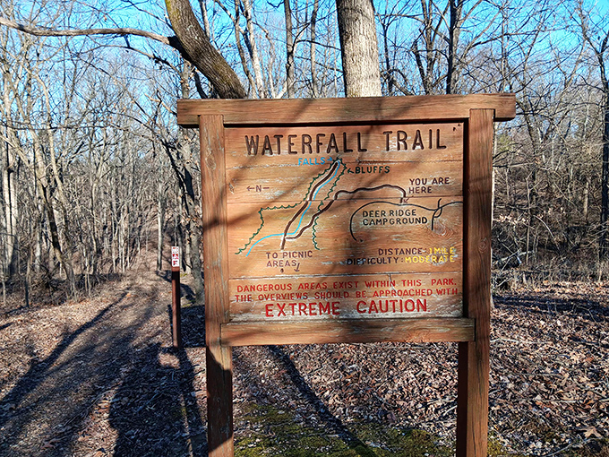 Trail Sign: Ready for adventure? This rustic wooden sign guides you along the moderate one-mile trek to see the beautiful falls.