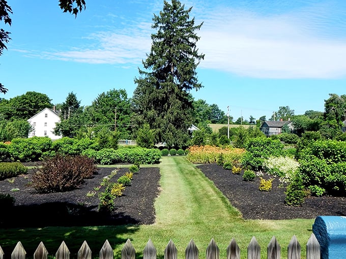 Manicured pathways wind through gardens designed with the same precision and care that defined the original community.