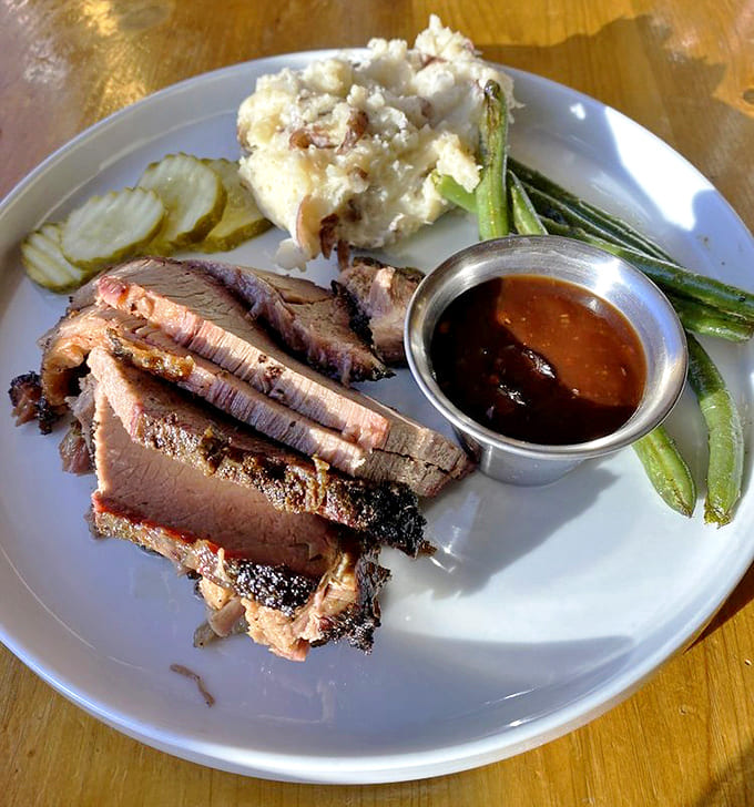Brisket so tender it practically surrenders to your fork, with that perfect pink smoke ring that barbecue dreams are made of.