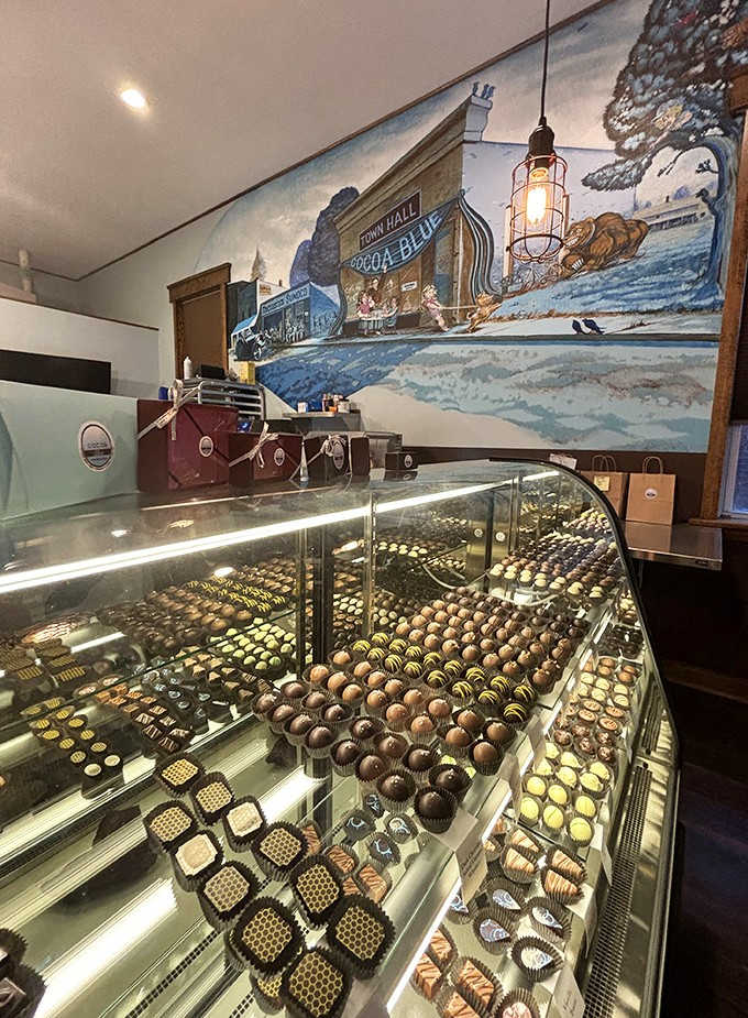 The display case showcases rows of handcrafted truffles, each one a miniature work of art with flavors ranging from classic to adventurous.