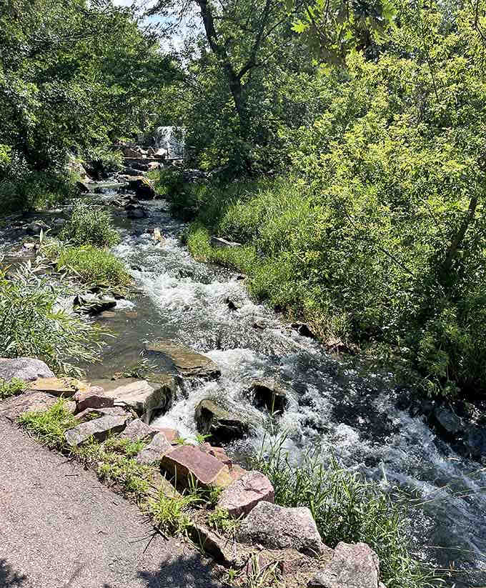 The gentle flow over layered stone reflects centuries of natural and cultural history in one view.