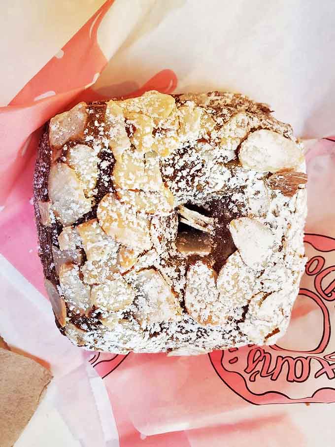 This almond croissant looks like it's wearing a powdered sugar snowstorm &ndash; a buttery, flaky marvel that shatters into delicious shards with each bite.
