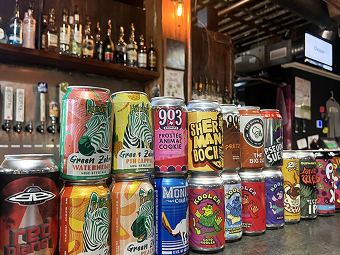 The colorful array of craft beer cans resembles a pixel art masterpiece, with local favorites and national treasures sharing shelf space.