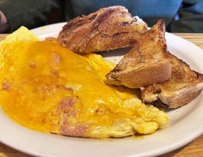 A perfect omelet meets perfectly toasted bread in a breakfast duet that sings of simple pleasures done extraordinarily well.