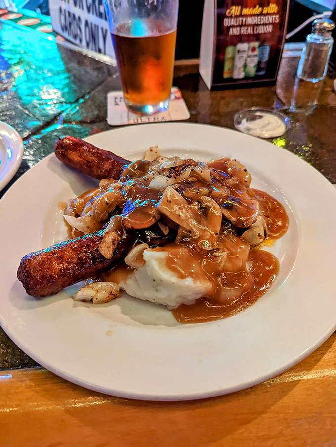 Bangers and mash elevated to an art form &ndash; juicy sausages nestled on cloud-like potatoes with mushrooms and gravy that demands to be savored.