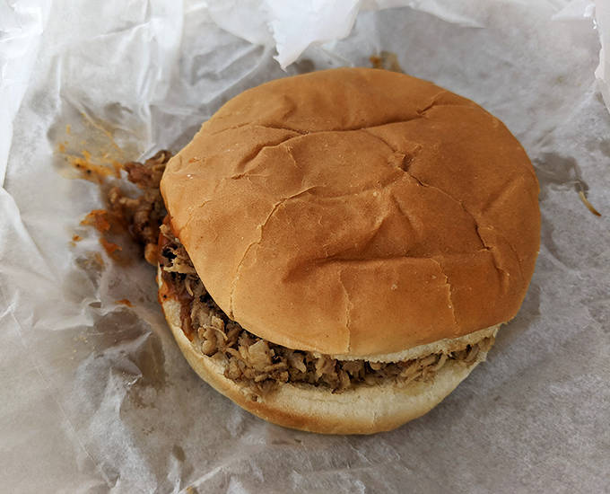 Unwrapped like a present, this BBQ sandwich doesn't need fancy packaging &ndash; the chopped meat and perfect sauce create edible poetry on a bun.