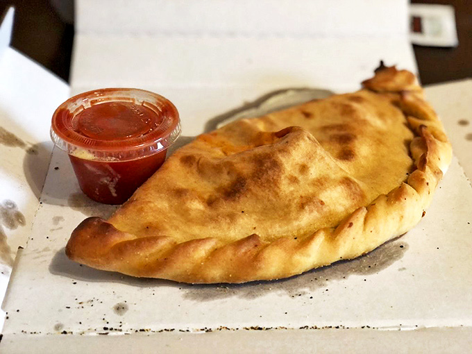 This golden-brown calzone isn't just dinner, it's a warm hug folded into a perfect crescent, waiting to release its steamy, cheesy secrets.