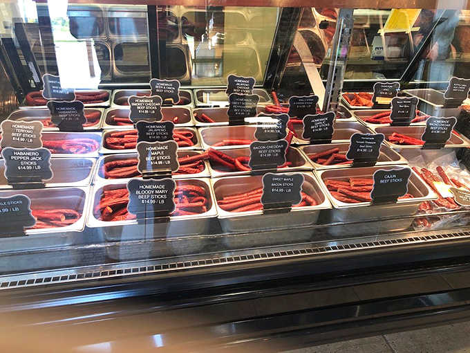 Colorful rows of homemade beef sticks line the display case, offering portable protein perfection that makes commercial versions taste like sad meat crayons.