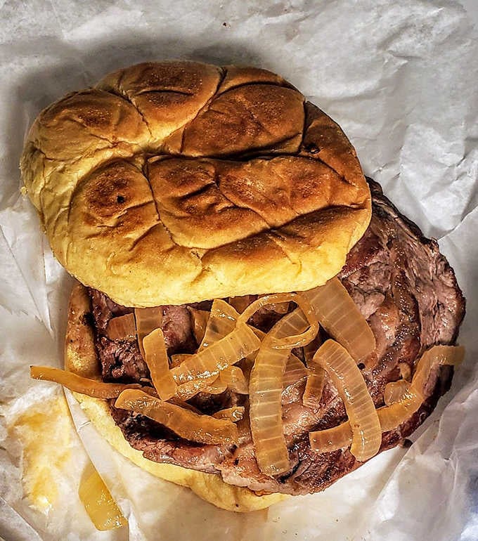 A ribeye sandwich that would make carnivores weep with joy &ndash; tender beef piled high with sweet caramelized onions on a pillowy bun.