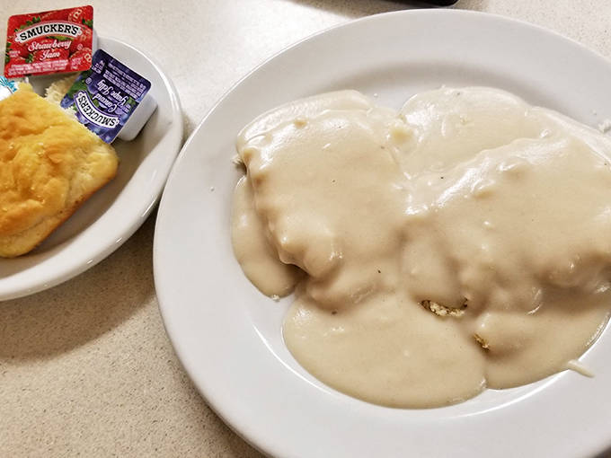 The perfect breakfast trinity: heavenly biscuits smothered in gravy with a side of buttery toast &ndash; carb lovers, rejoice!