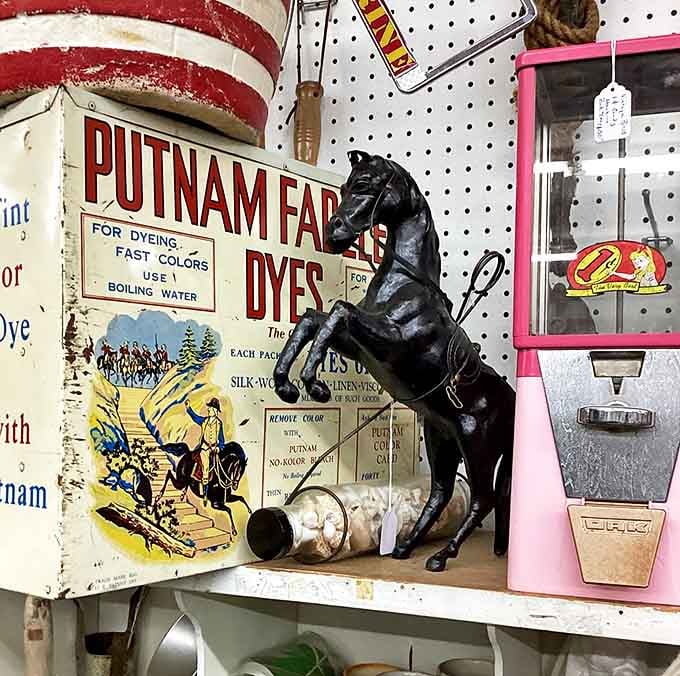 This vintage black horse figure stands guard over collectibles &ndash; a silent sentinel from another era when decorative animals weren't just for children's rooms.