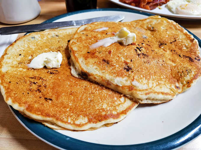 Pancakes the size of dinner plates somehow maintain cloud-like fluffiness, with blueberries that burst with every heavenly bite.