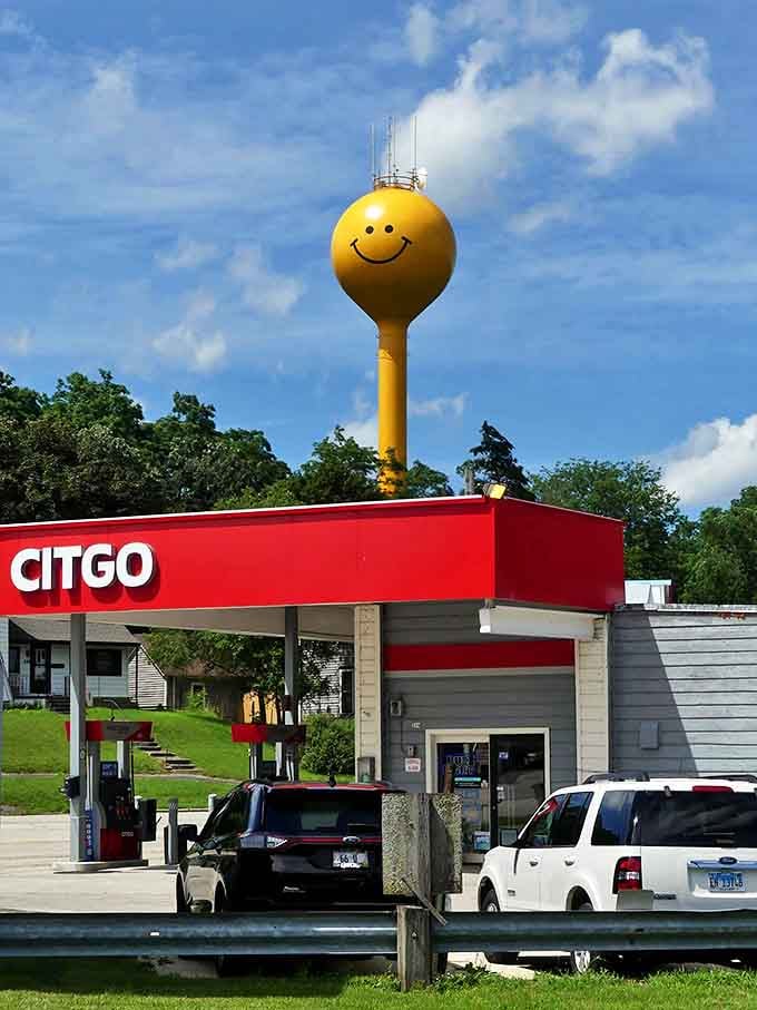 Morning light catches the vibrant yellow paint, making the tower glow like a beacon of good cheer above the town.