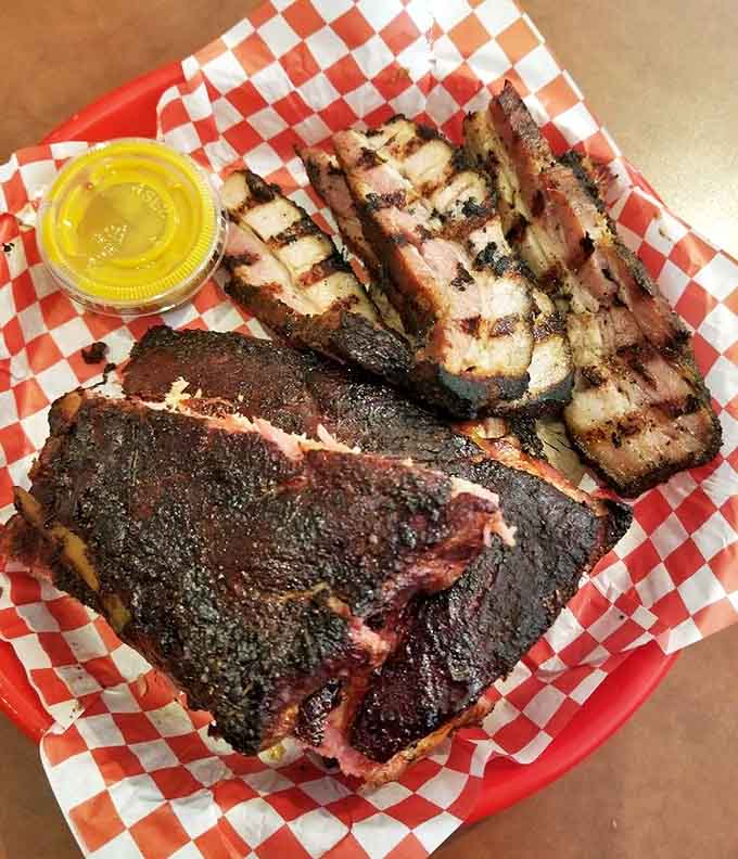 Glistening ribs with perfect bark alongside slices of brisket, a duo that would make even Texas pitmasters tip their hats in respect.