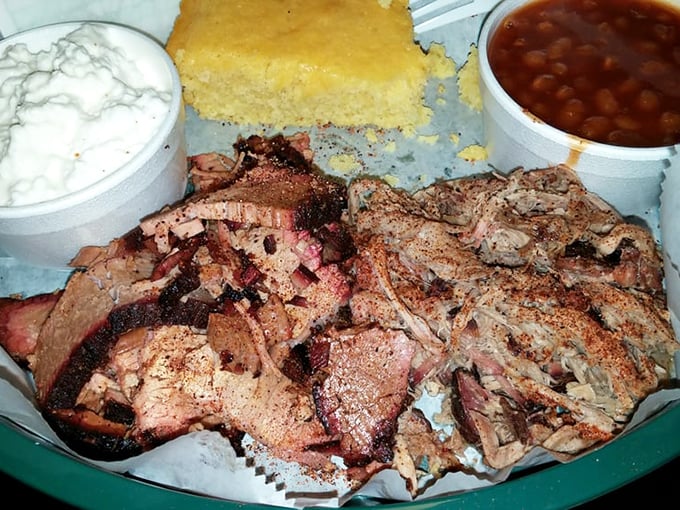 A barbecue plate that's worth every calorie, featuring tender slices of brisket alongside perfectly smoked sides that refuse to be upstaged.