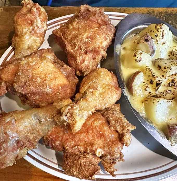 Comfort food nirvana: crispy broasted chicken alongside bubbling au gratin potatoes that stretch with cheese in all the right ways.