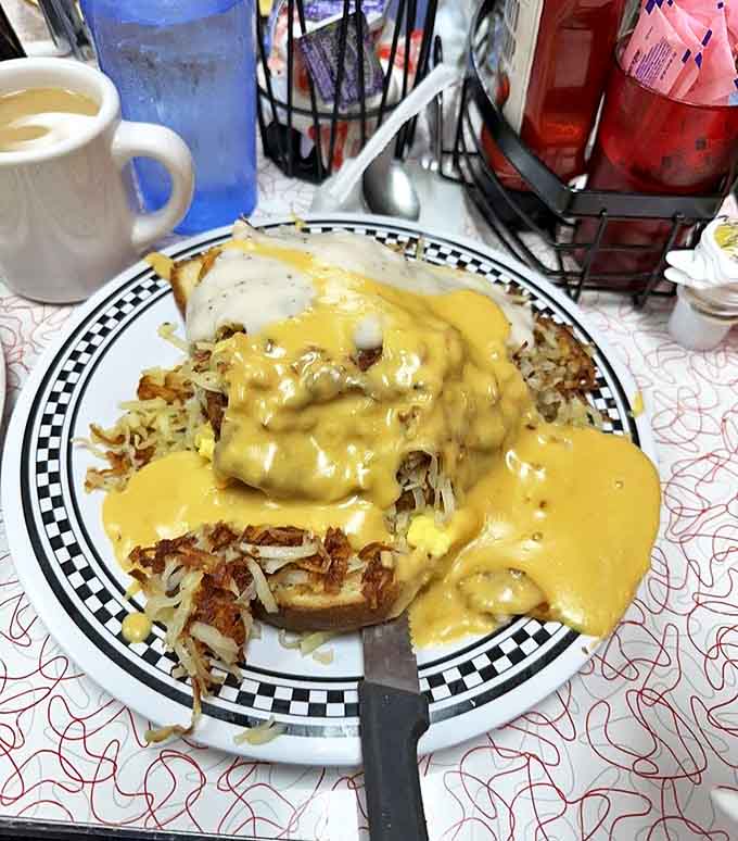 Country-fried heaven: A crispy breaded steak smothered in peppery gravy with hash browns standing by &ndash; cardiac concerns temporarily suspended for pure comfort.