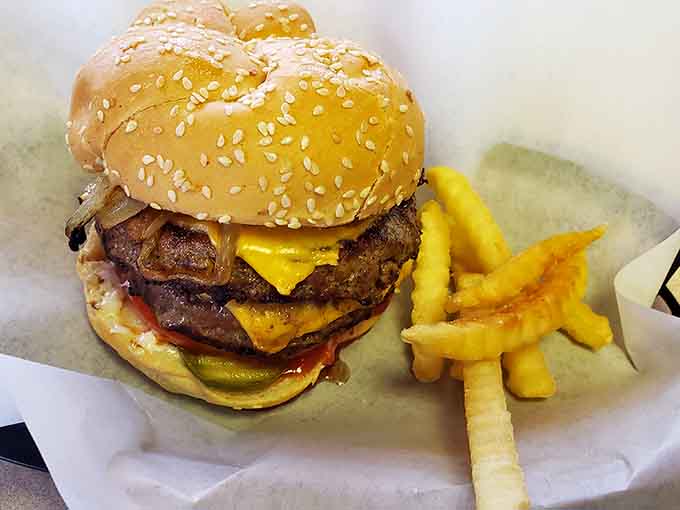 A sesame seed bun cradles char-grilled perfection while crinkle fries stand ready to complete this iconic Illinois meal experience.