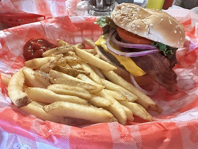 A juicy cheeseburger piled high with onions and pickles, glowing like it knows it stole the show, reminding me of the simple joy of roadside diners that never try too hard yet always deliver.