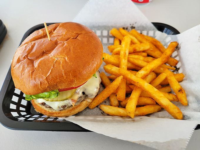 Simple perfection on a plate &ndash; a juicy cheeseburger alongside golden fries that remind you why classics became classics in the first place.