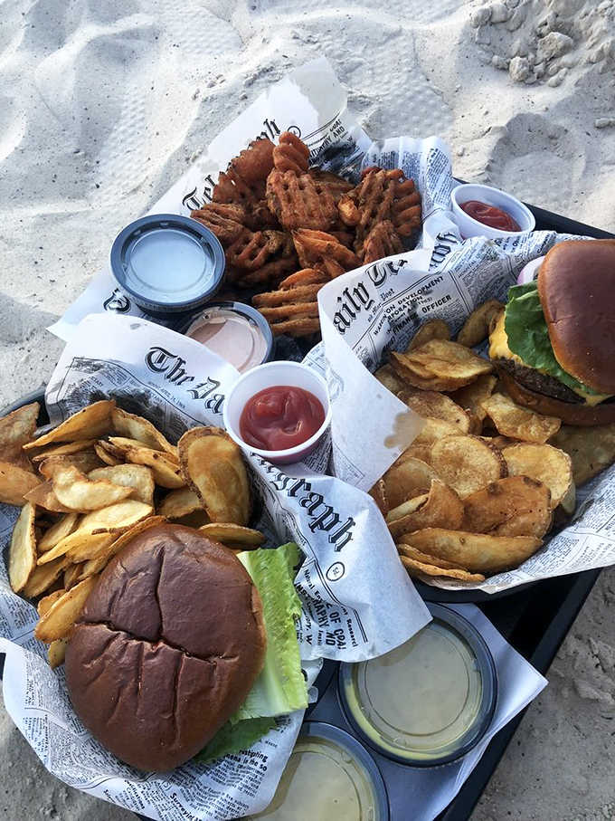 That cheeseburger paired with sweet potato waffle fries is basically summer vacation on a plate, hold the sunburn.