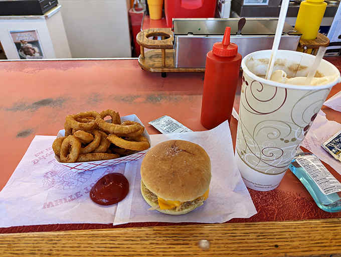 A perfect trifecta: golden onion rings, a cheesy turkey sandwich, and a frosty shake &ndash; the holy trinity of drive-in dining done right.