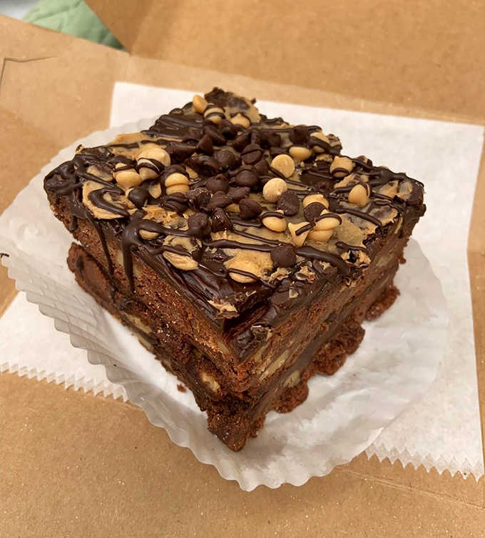 This chocolate brownie doesn't apologize for being rich, fudgy, and topped with enough chocolate and peanuts to make your dentist nervous.