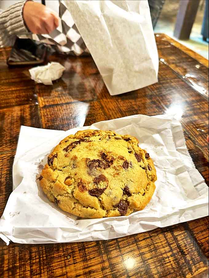 This chocolate chip cookie is roughly the size of a dinner plate and makes zero apologies about it.