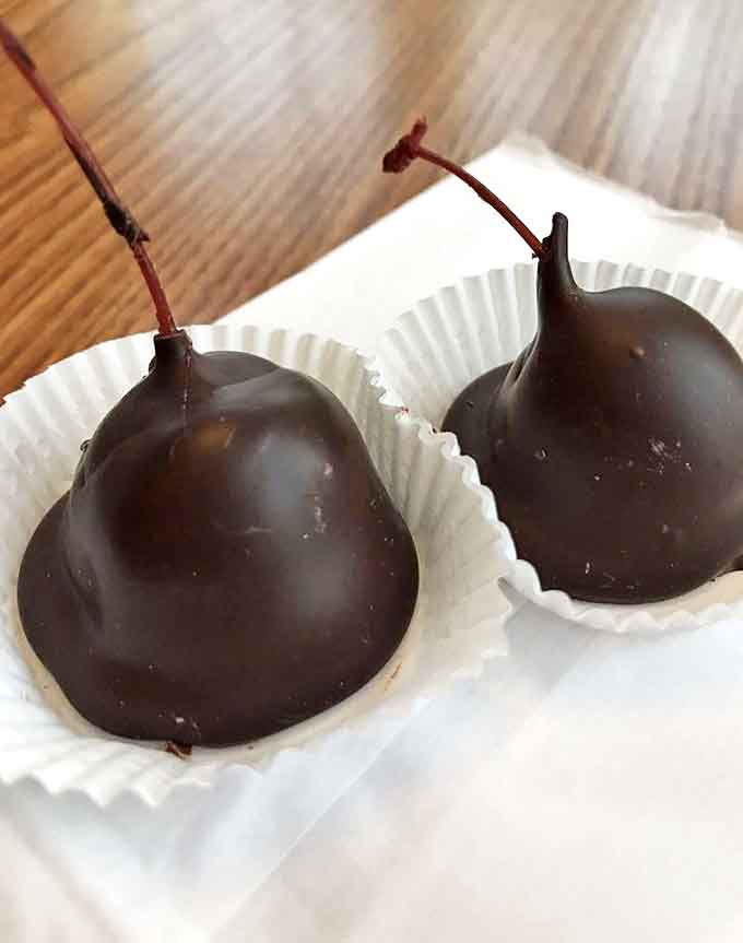 Plump cherries still on their stems, enrobed in rich chocolate &ndash; nature's perfect handle for a decadent treat.