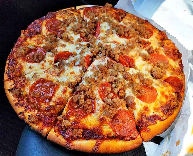 Meat lovers rejoice! This carnivore's dream combines pepperoni, sausage, and ground beef in perfect harmony on that famous homemade crust.