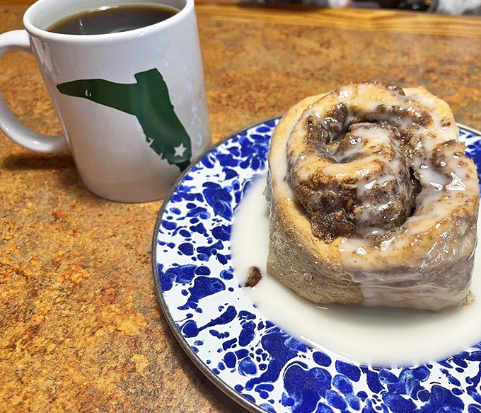 Morning perfection: A Florida-shaped mug of steaming coffee stands guard beside a cinnamon roll that's worth every mile of the drive.