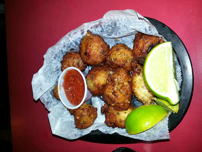 Golden-fried conch fritters &ndash; crunchy outside, tender inside &ndash; served with zesty sauce and lime wedges that brighten each bite of this Keys classic.