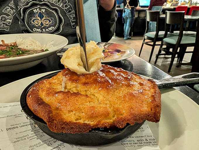 That cornbread skillet arrives sizzling hot, its golden crust hiding a tender interior that's begging for a swipe of melting butter.