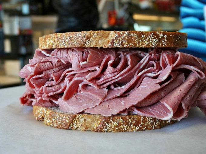 A mountain of hand-sliced corned beef on rye that makes other sandwiches feel like they need to hit the gym.