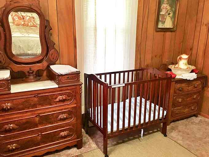 This nursery corner whispers of generations past with its antique wooden crib and dresser &ndash; history's embrace for the youngest guests.