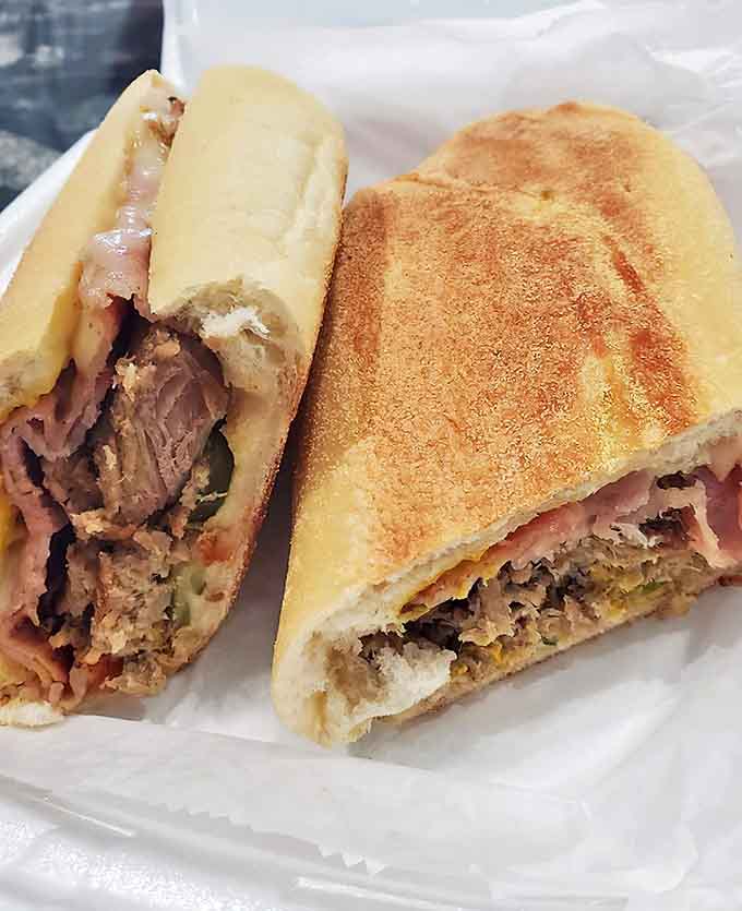 Behold the architectural marvel that is La Creaci&oacute;n's Cuban sandwich &ndash; layers of porky perfection nestled between bread that deserves its own fan club.