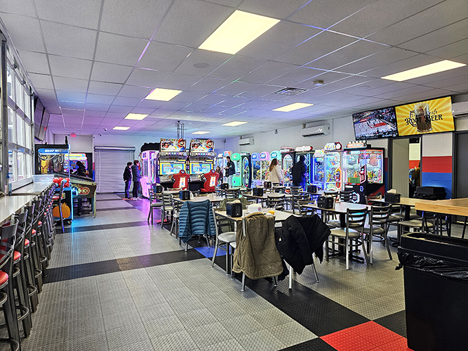 The communal tables foster friendly competition and shared experiences, turning strangers into friends over the universal language of high scores.