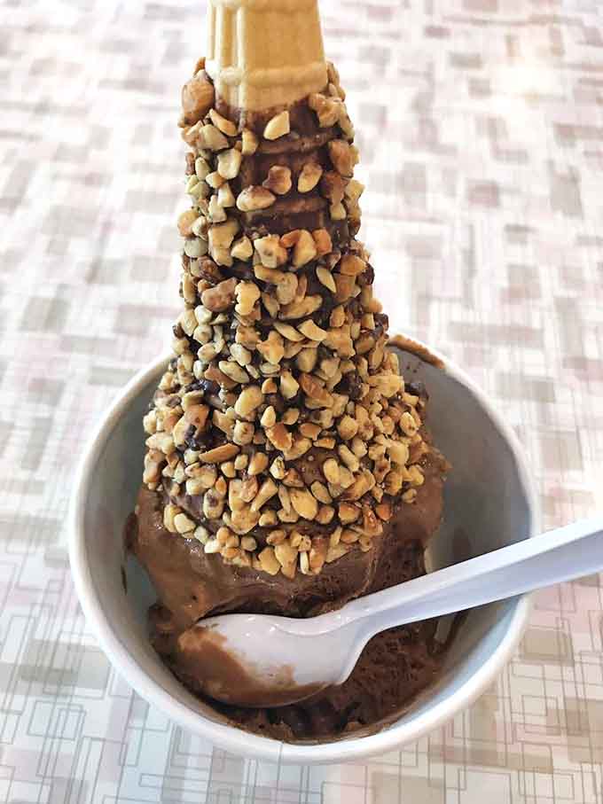 Chocolate ice cream crowned with nuts creates a textural symphony &ndash; crunchy meets creamy in a dessert that's worth every calorie.